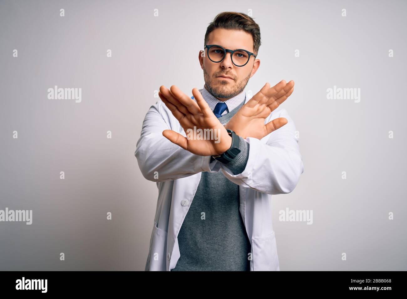 Young doctor man with blue eyes wearing medical coat and stethoscope ...