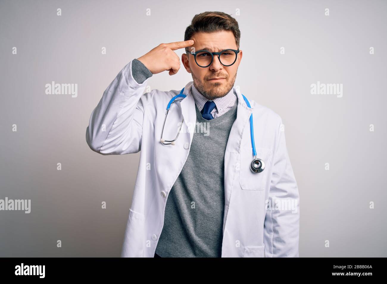 Young doctor man with blue eyes wearing medical coat and stethoscope ...