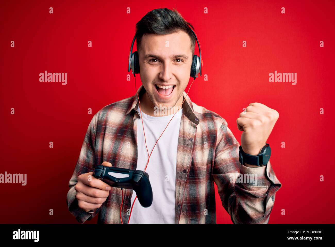 Young handsome caucasian gamer man playing video games using console ...