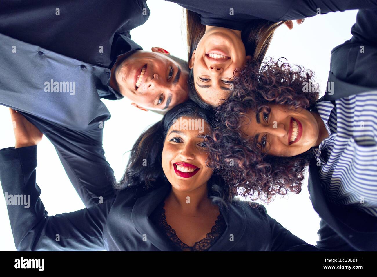 Group of business workers smiling happy. Standing with heads together ...