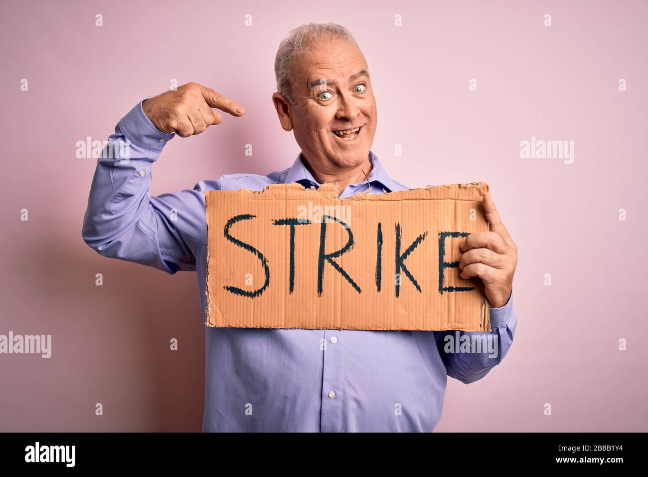 Middle age man asking for rights holding banner with strike message ...