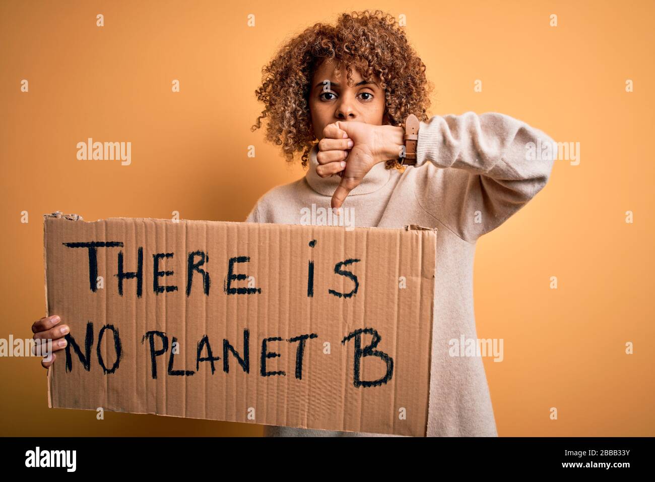 African american activist woman asking for environment holding banner ...