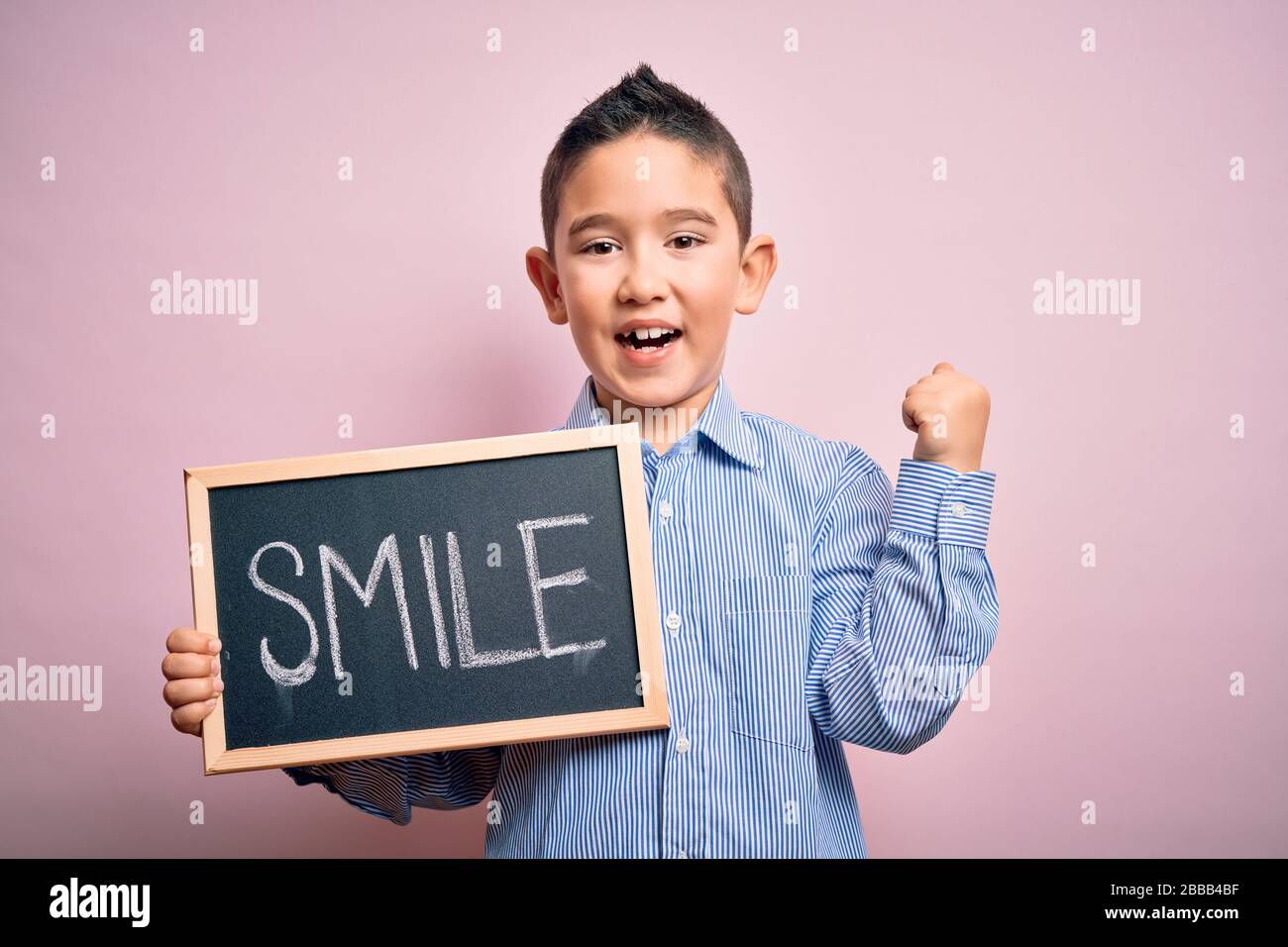 Young little boy kid showing blackboard with smile word as happy ...