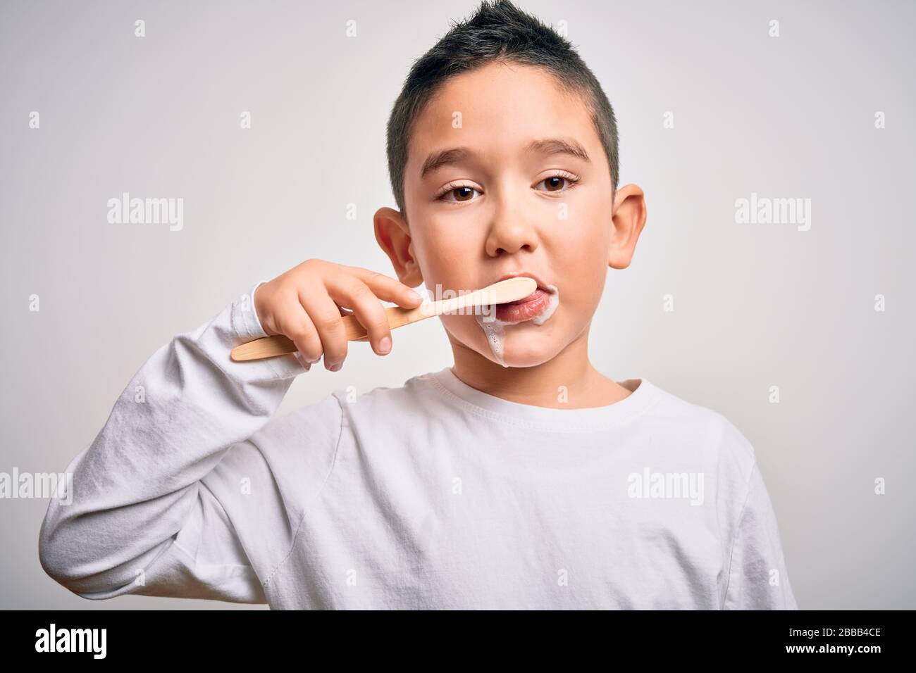 Young little kid boy brushing her teeth using tooth brush and oral ...