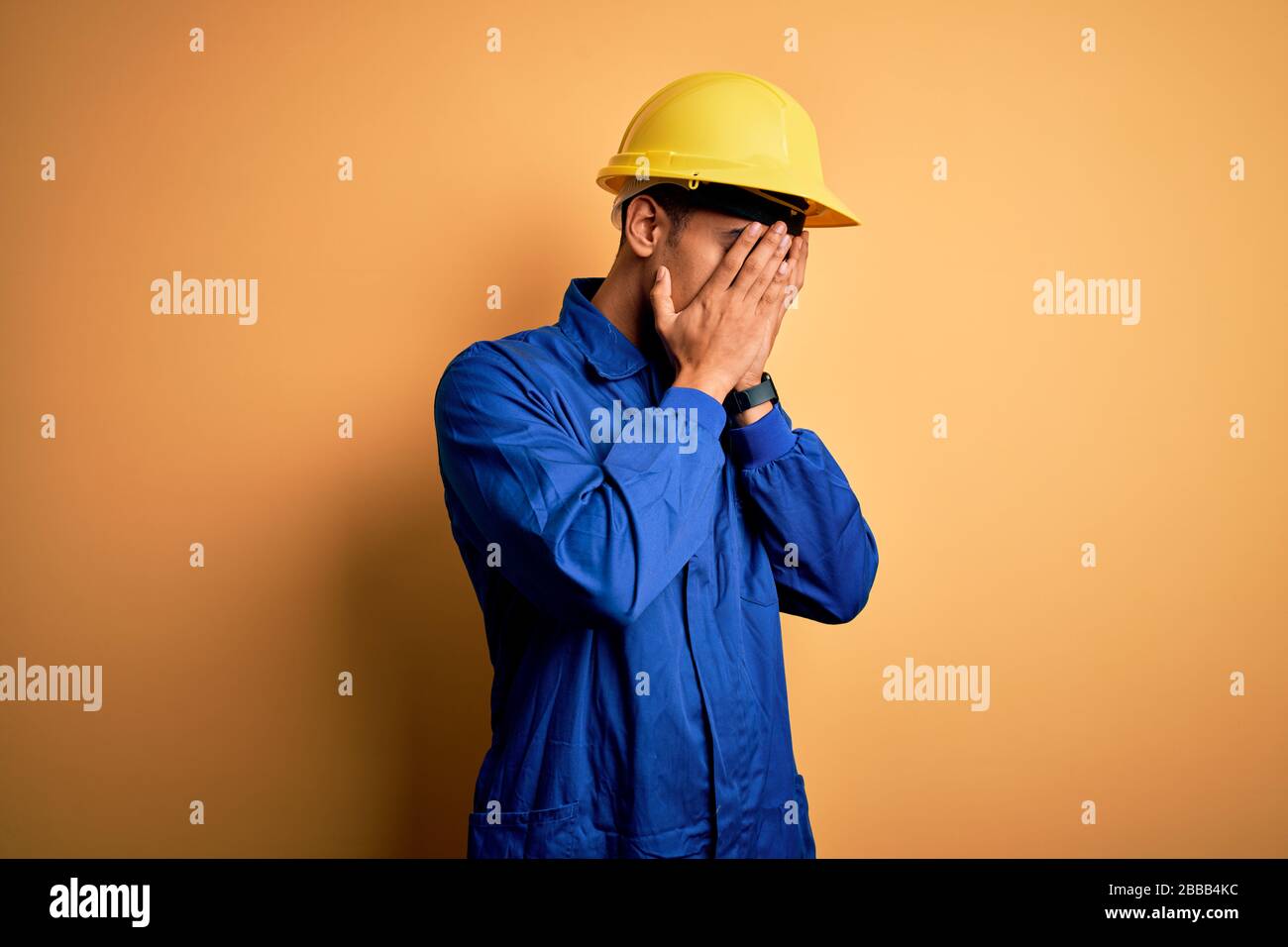Young handsome african american worker man wearing blue uniform and ...
