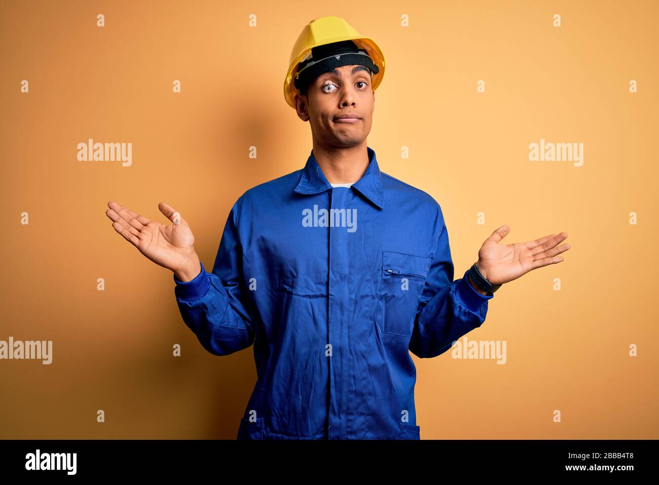 Young handsome african american worker man wearing blue uniform and ...