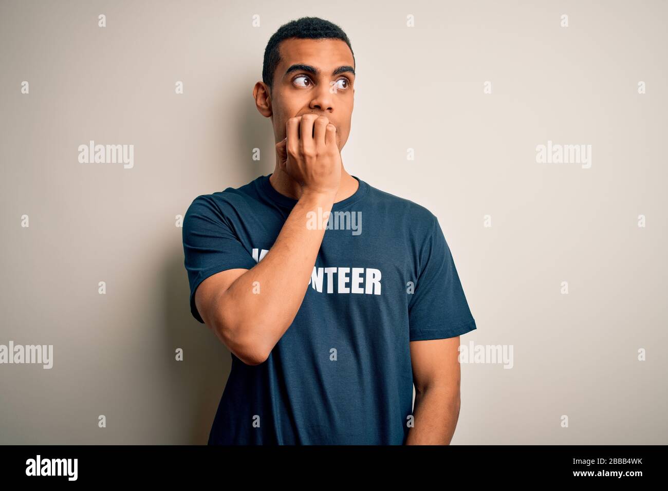 Young handsome african american man volunteering wearing t-shirt with ...