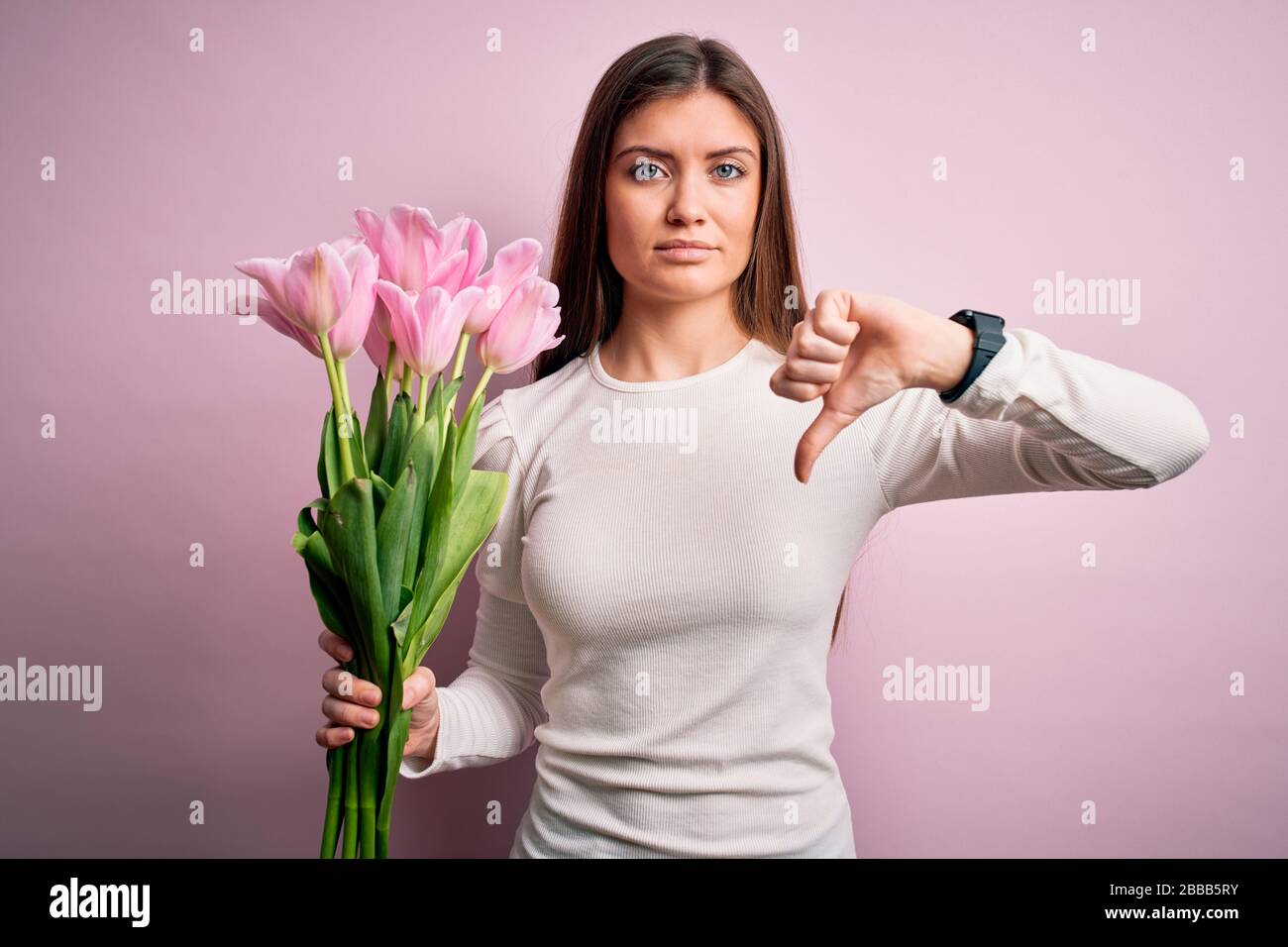 Young beautiful romantic woman with blue eyes holding beauty bouquet of ...