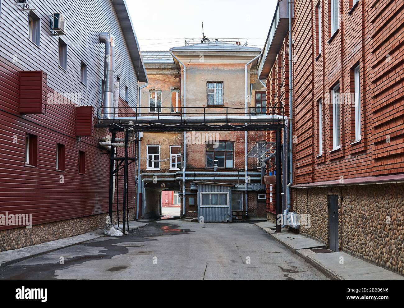 urban landscape - a back alley with vintage and new buildings and ...