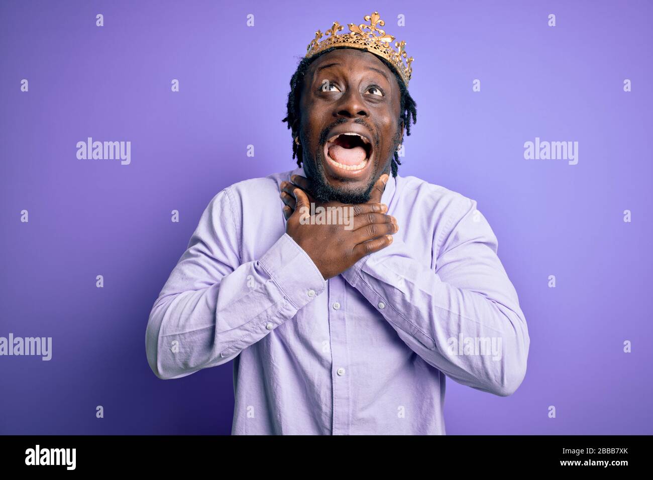 Young african american man wearing golden crown of king over isolated ...