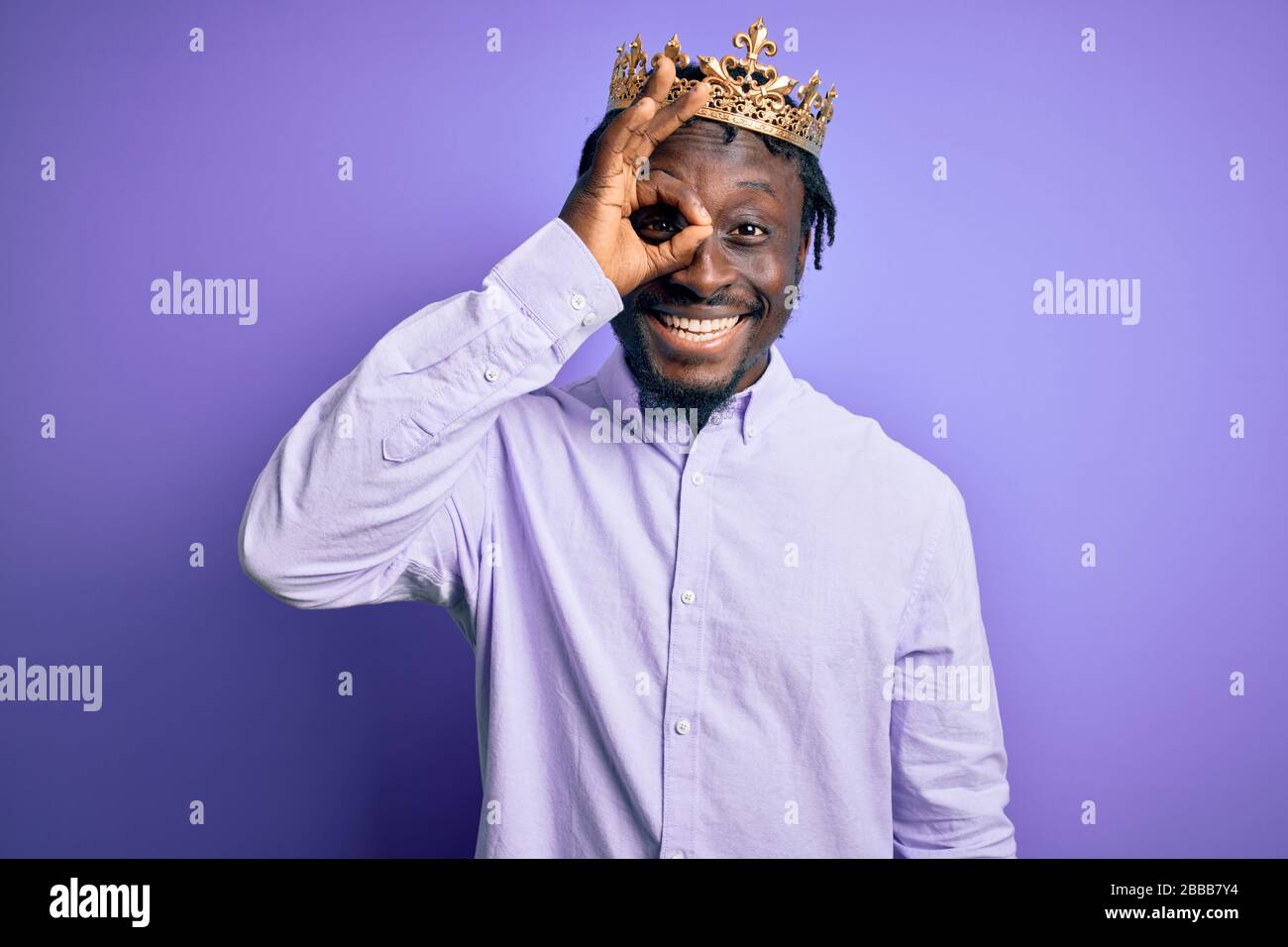 Young african american man wearing golden crown of king over isolated ...