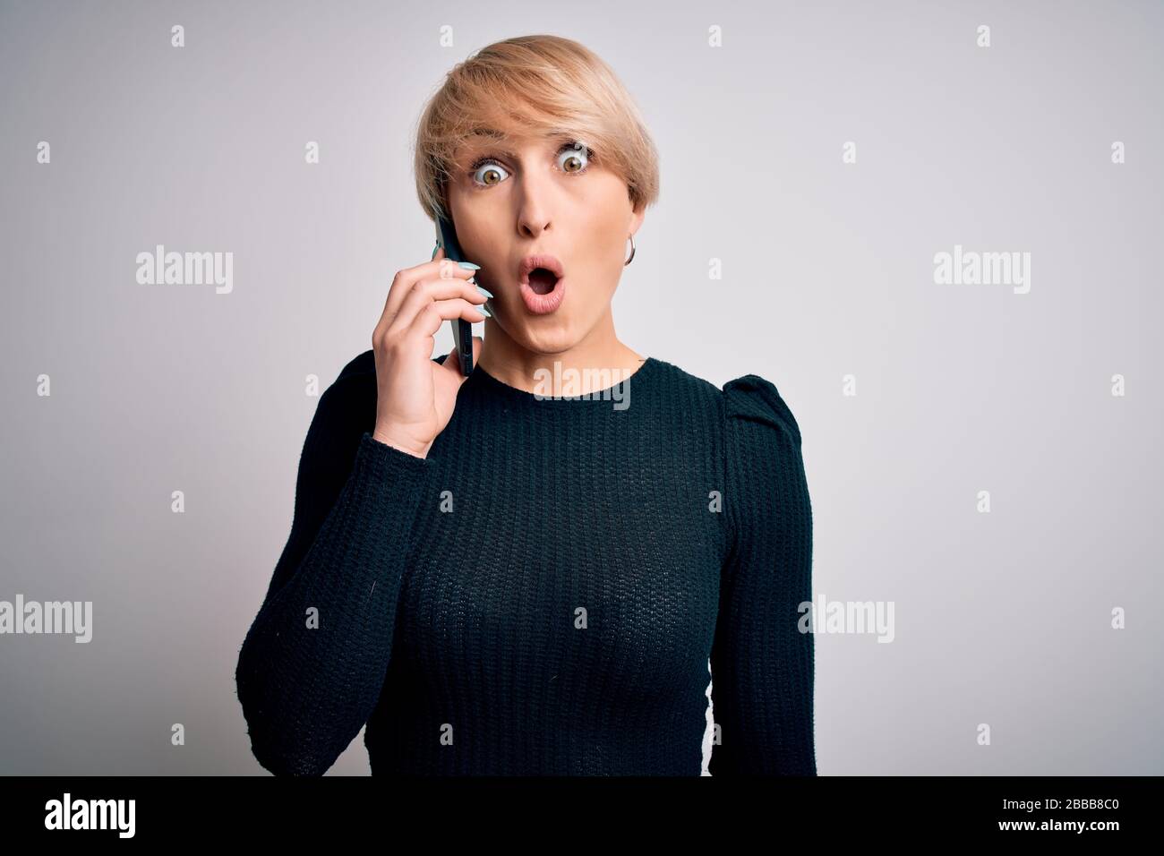 Young blonde woman with short hair having a conversation talking on ...