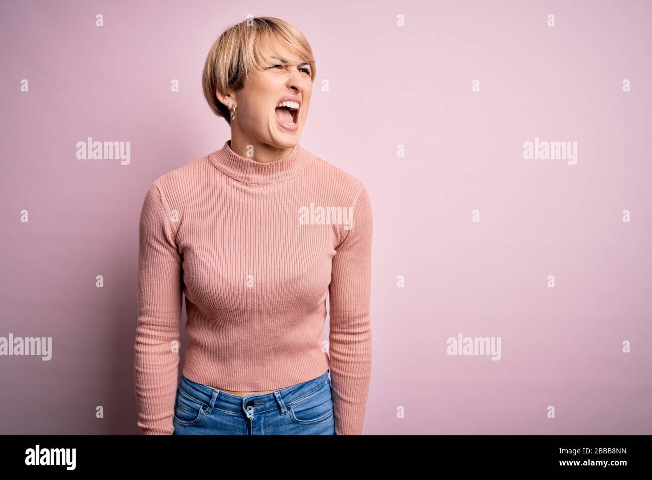 Young blonde woman with short hair wearing casual turtleneck sweater ...