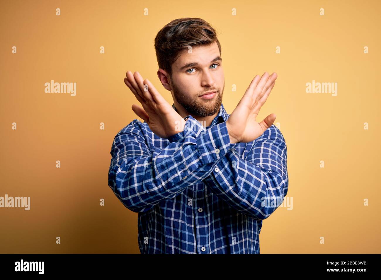 Young blond businessman with beard and blue eyes wearing shirt over ...