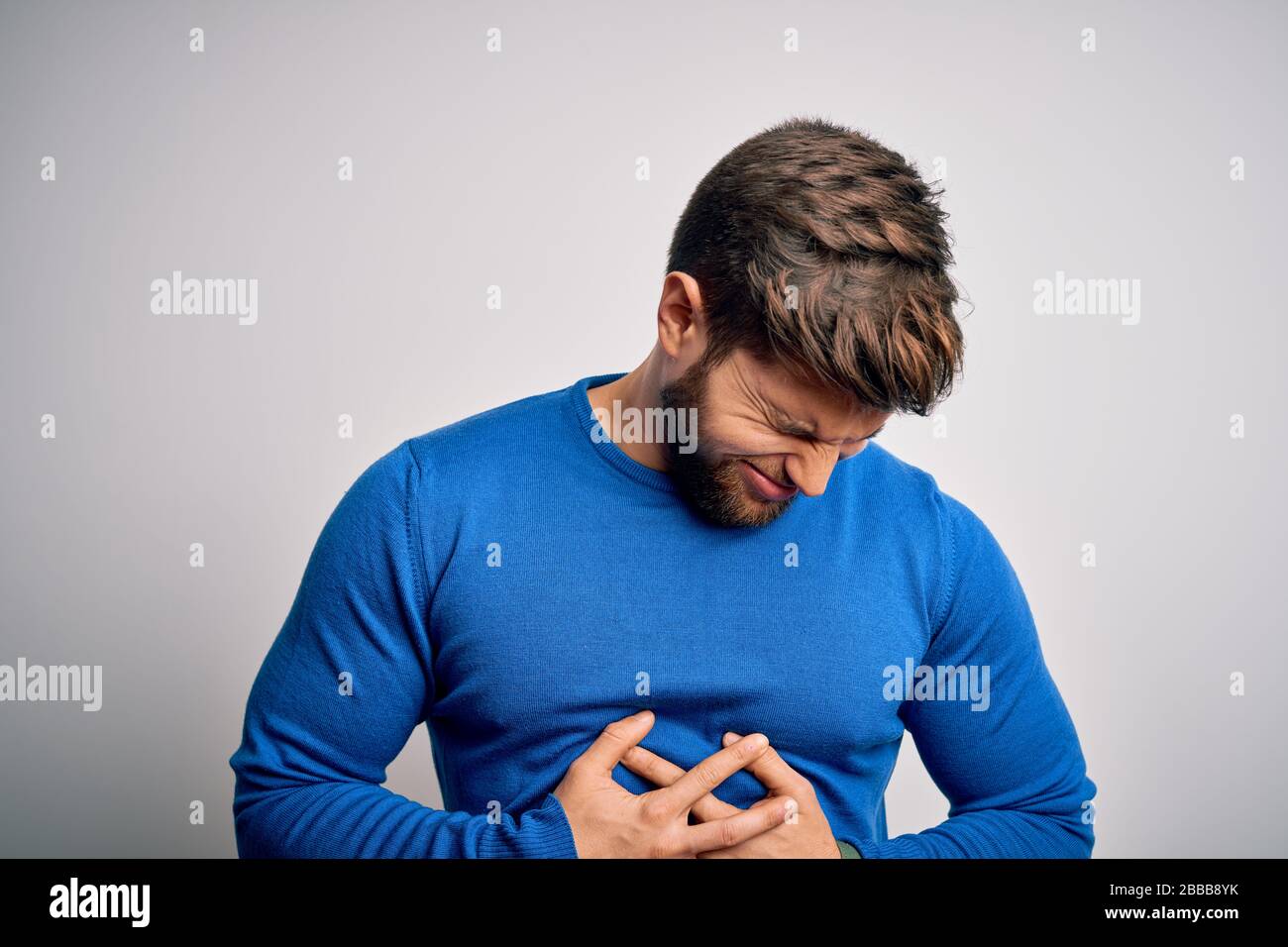 Young handsome blond man with beard and blue eyes wearing casual ...
