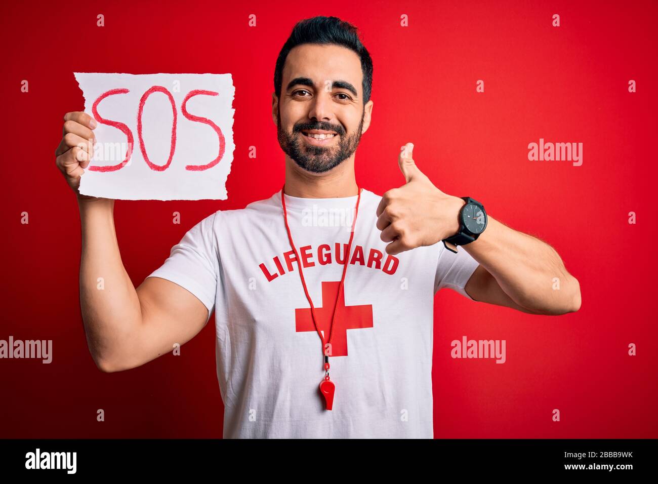 Young handsome lifeguard man with beard wearing whistle holding sos ...