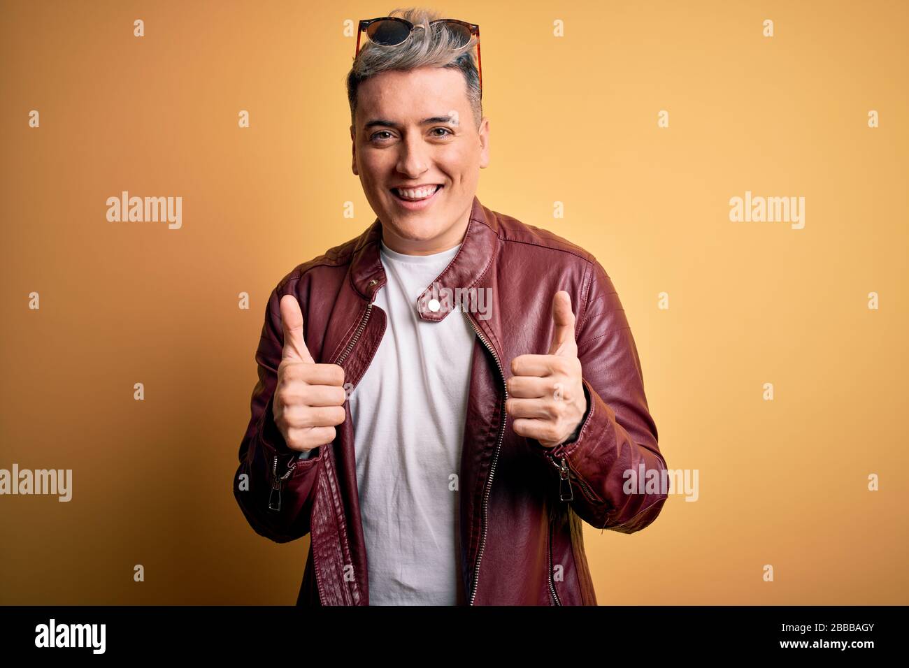 Young handsome modern man wearing fashion leather jacket and sunglasses ...