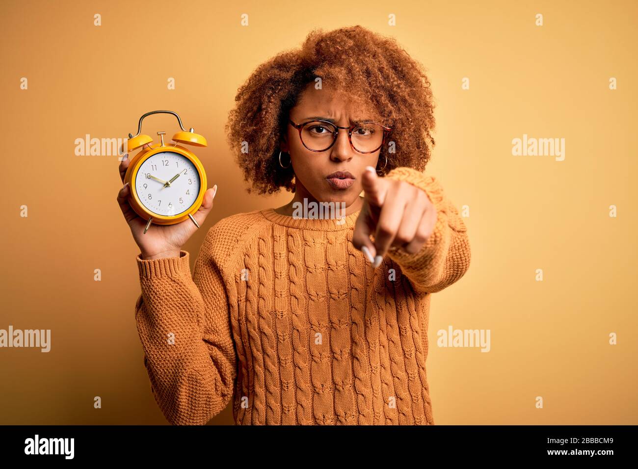 Young beautiful African American afro woman with curly hair holding ...