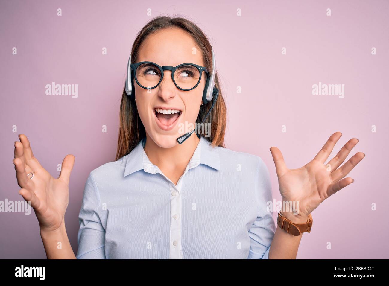 Young beautiful call center agent woman wearing glasses working using ...