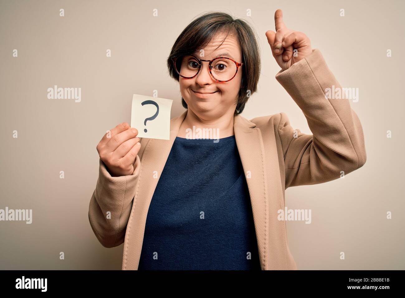 Young down syndrome business woman holding question mark paper as doubt ...