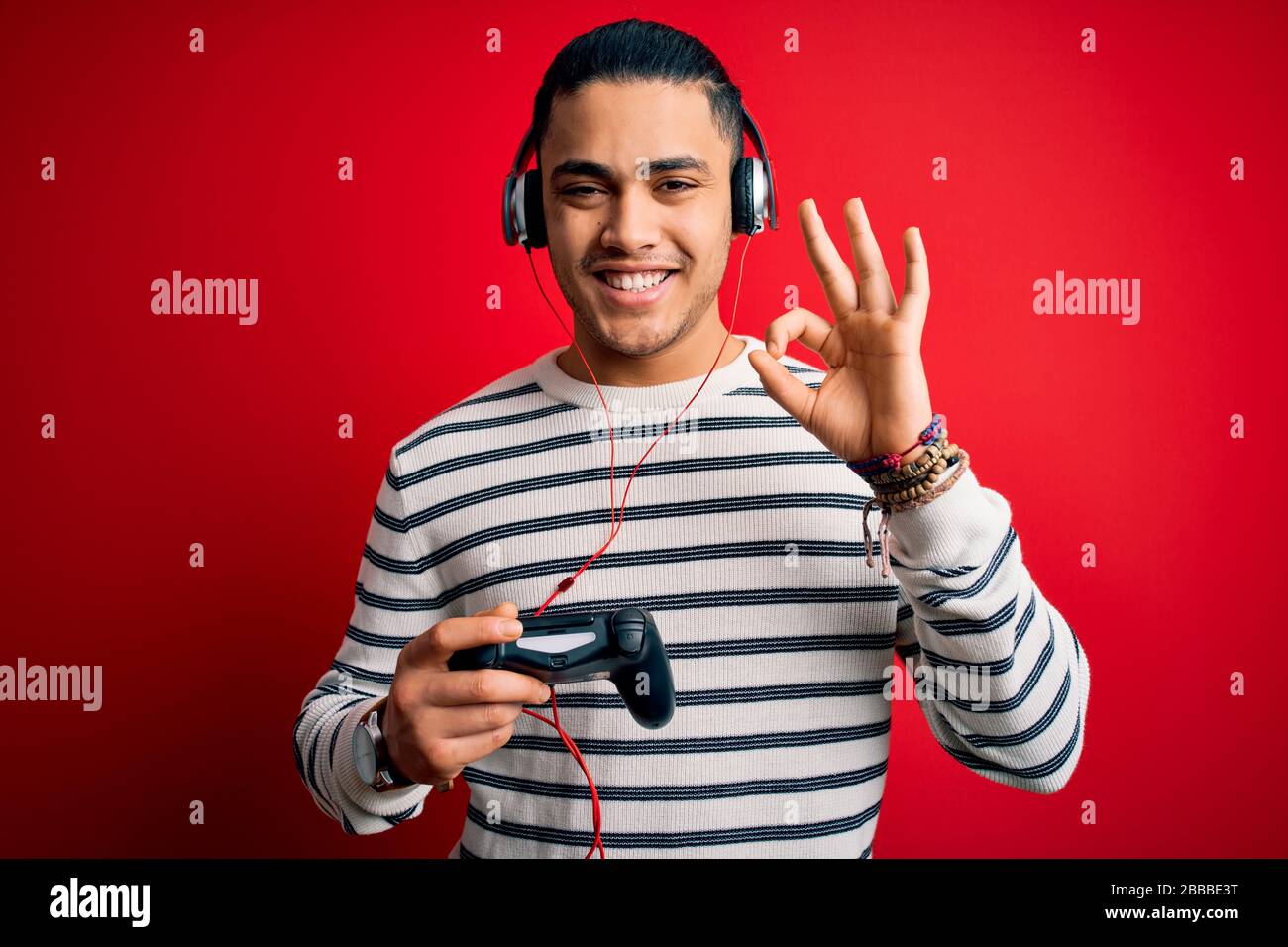 Young brazilian gamer man playing video game using joystick and ...
