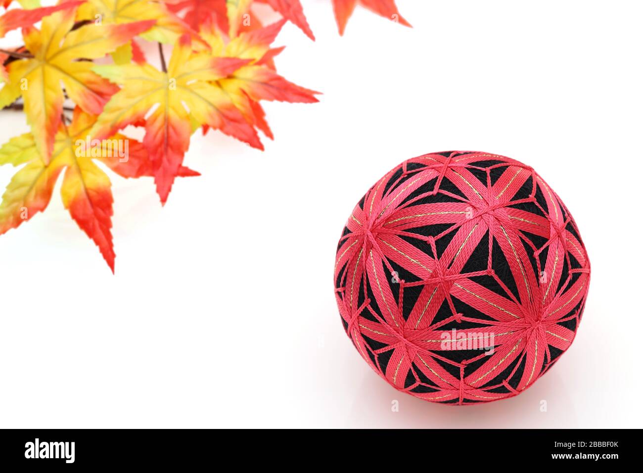 Japanese traditional temari ball with maple leaves on white background ...