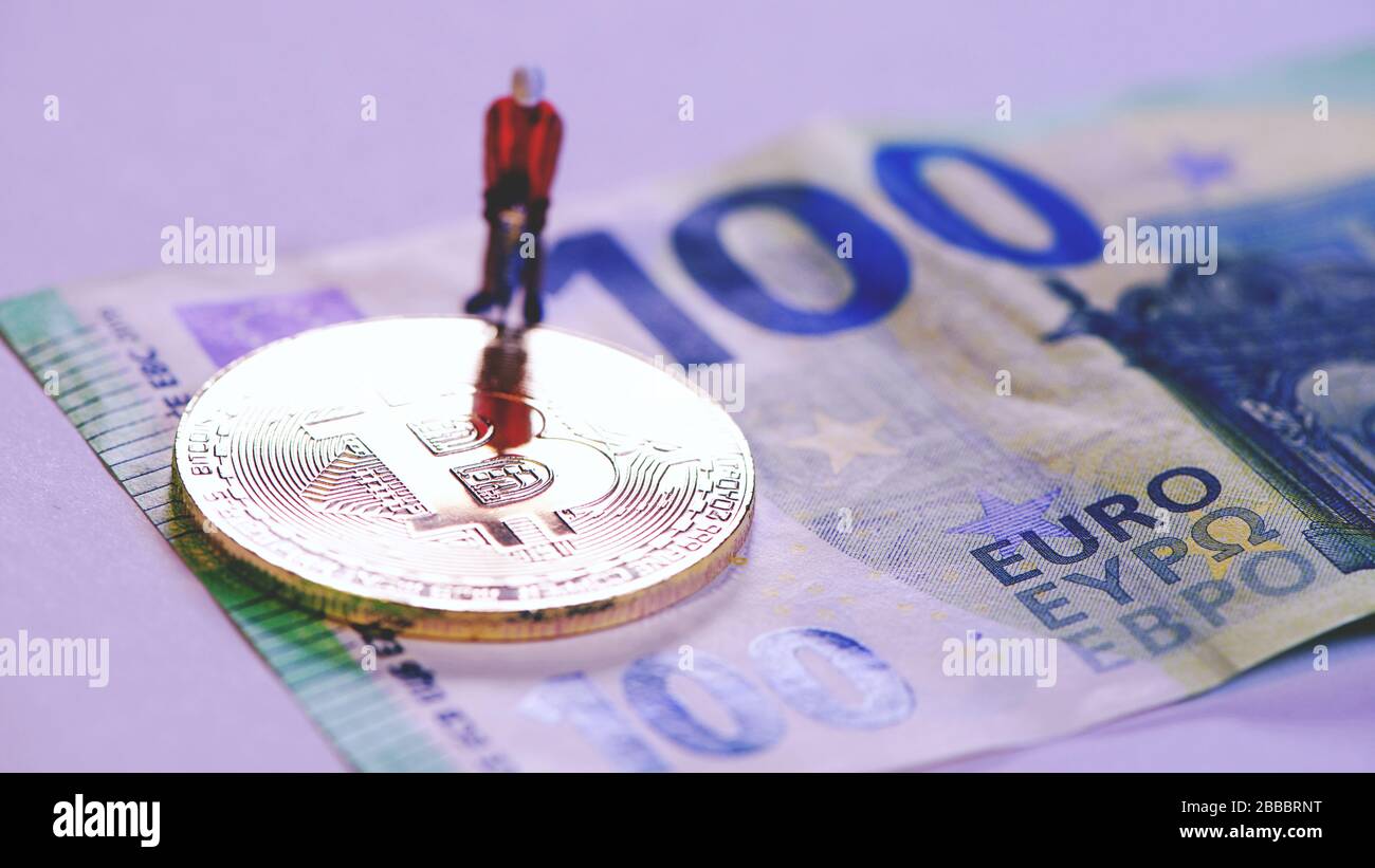 Bitcoin mining: Miner figurine digging ground to uncover big shiny ...