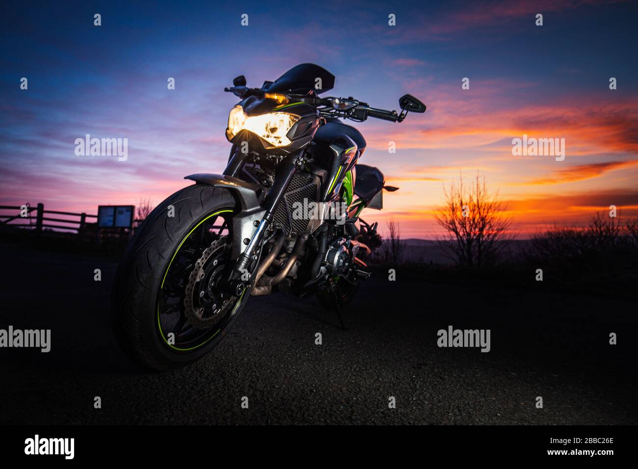 Low angle shoot of modern sport motorcycle against vivid twilight sky ...