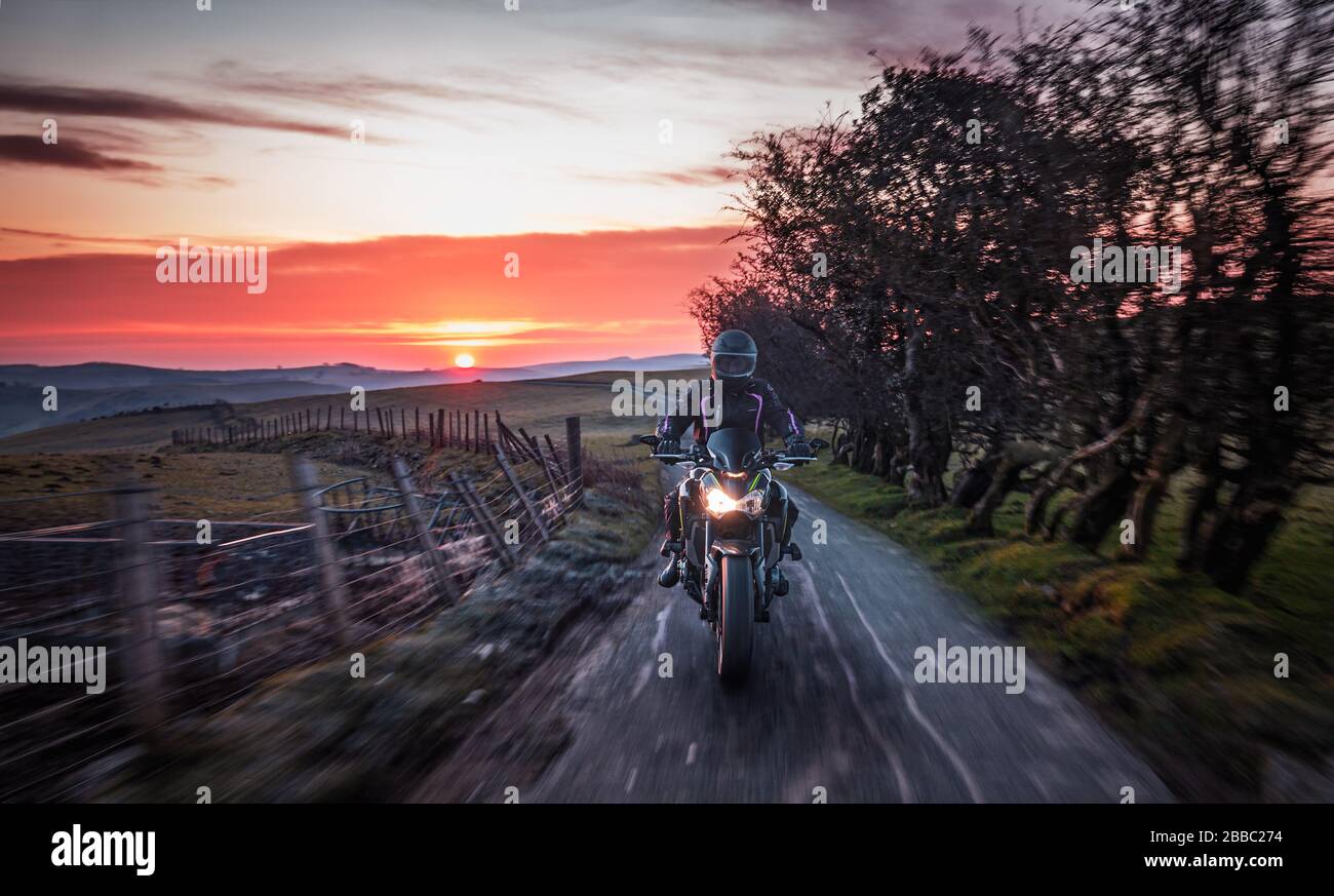 Motorcycle ride across scenic countryside at beautiful sunrise ...