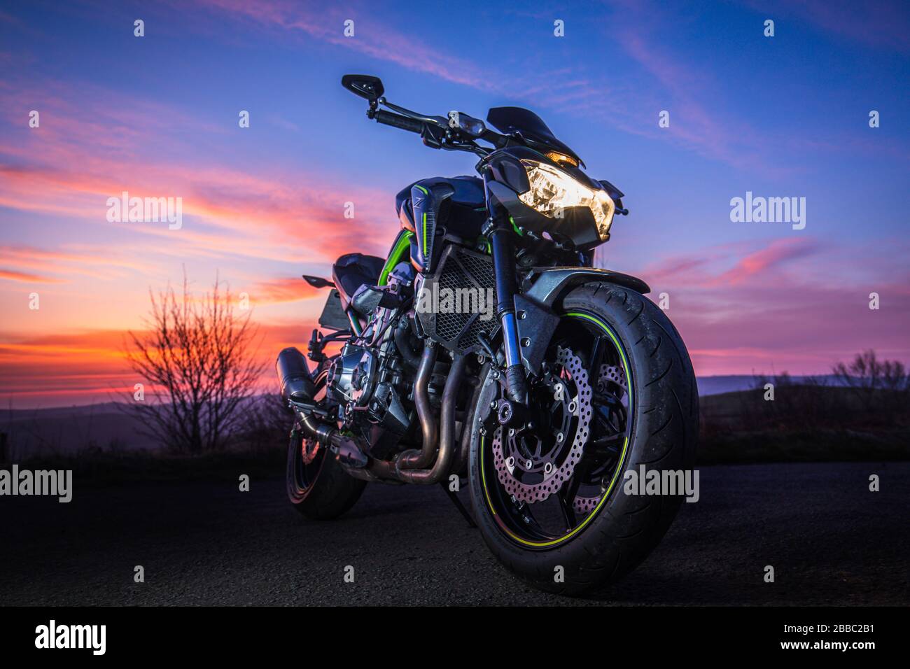Low angle shoot of modern sport motorcycle against vivid twilight sky ...
