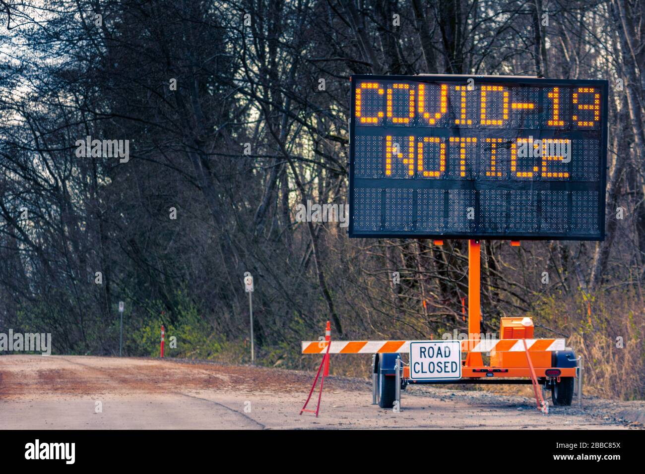 Large electronic notification sign on rural street in wooded area ...