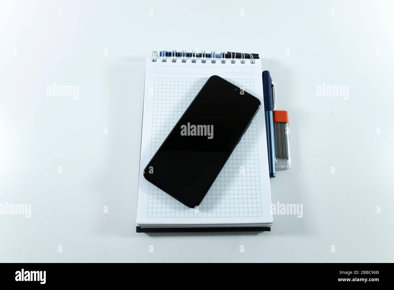 Concept of notepad phone pen. The photo was taken on white background ...