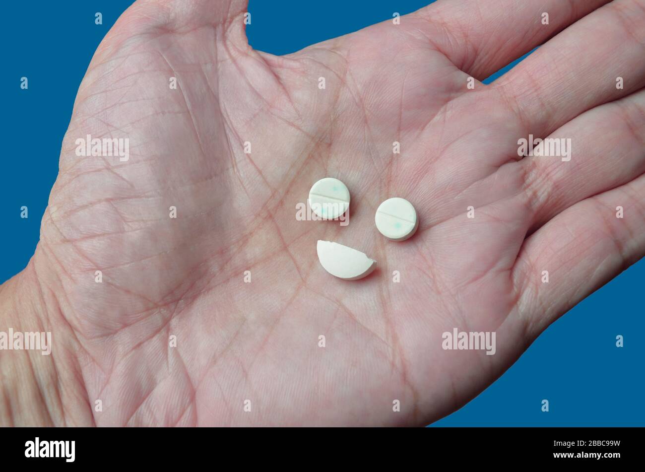 Drug dependence, illustrated by pills arranged to resemble happy face ...