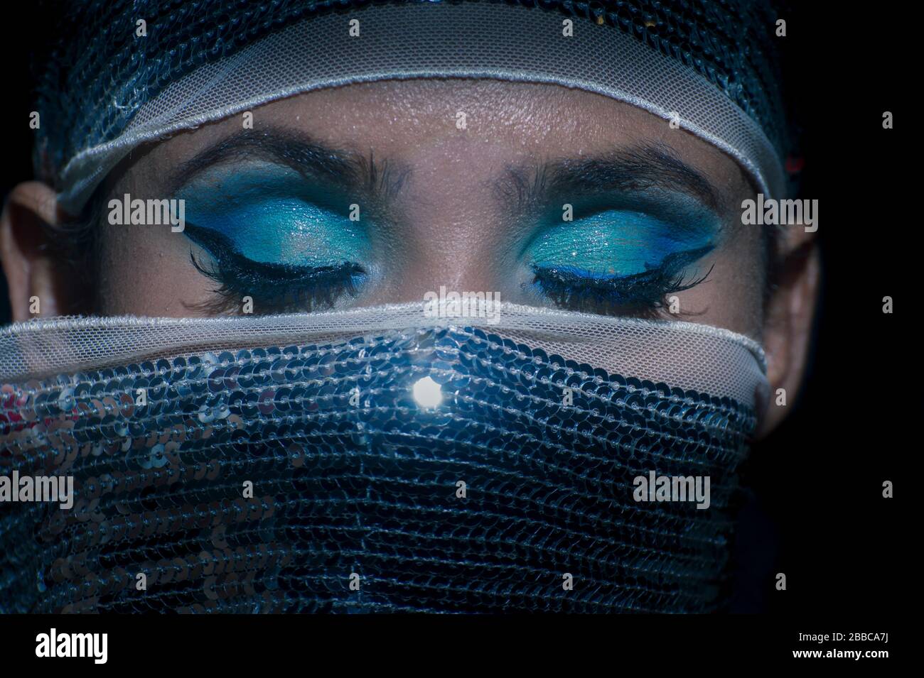 young girl face close up covered face with sequins cloth showing her ...