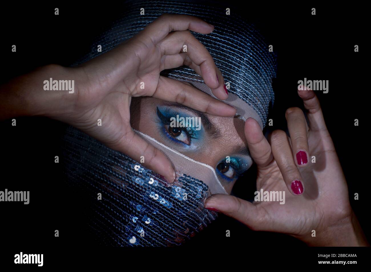 young girl face close up covered face with sequins cloth showing her ...