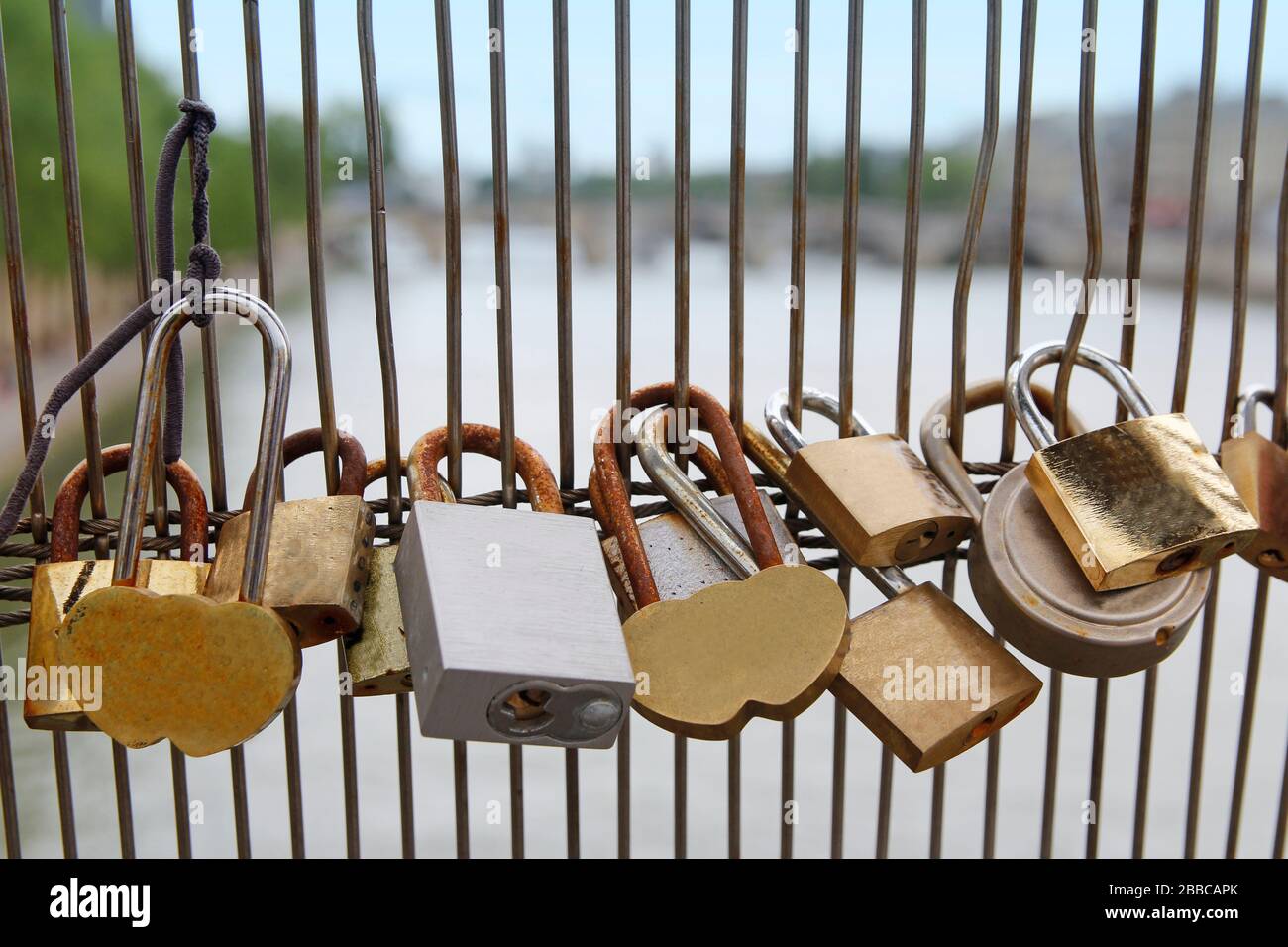 Padlock with the Eiffel Tower carving hanging on the fence of ...