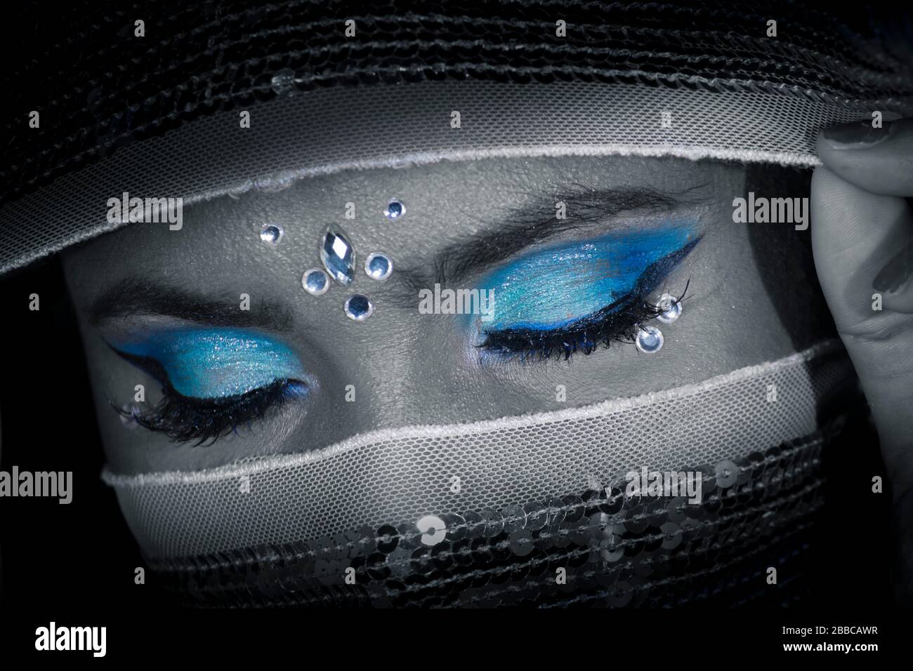 young girl face close up covered face with sequins cloth showing her ...