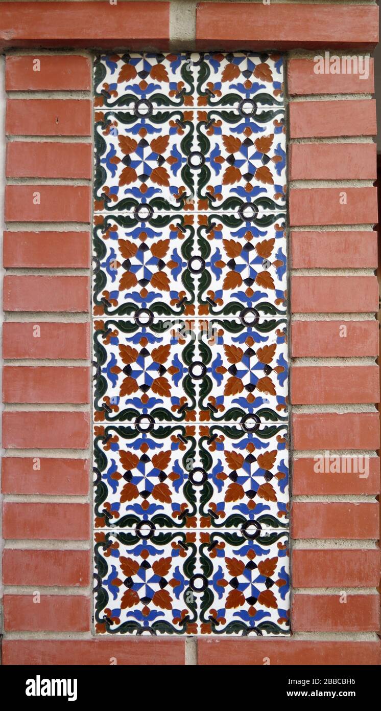 Closeup of decorative Tiles recessed in brick wall Stock Photo - Alamy