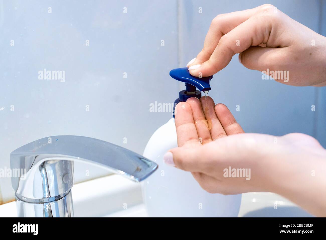 Close-up view of an unrecognizable female showing how to wash hands ...