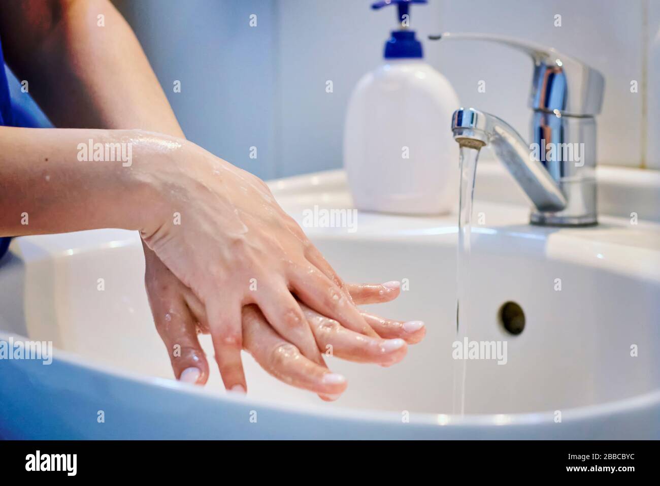 Close-up view of an unrecognizable female showing how to wash hands ...