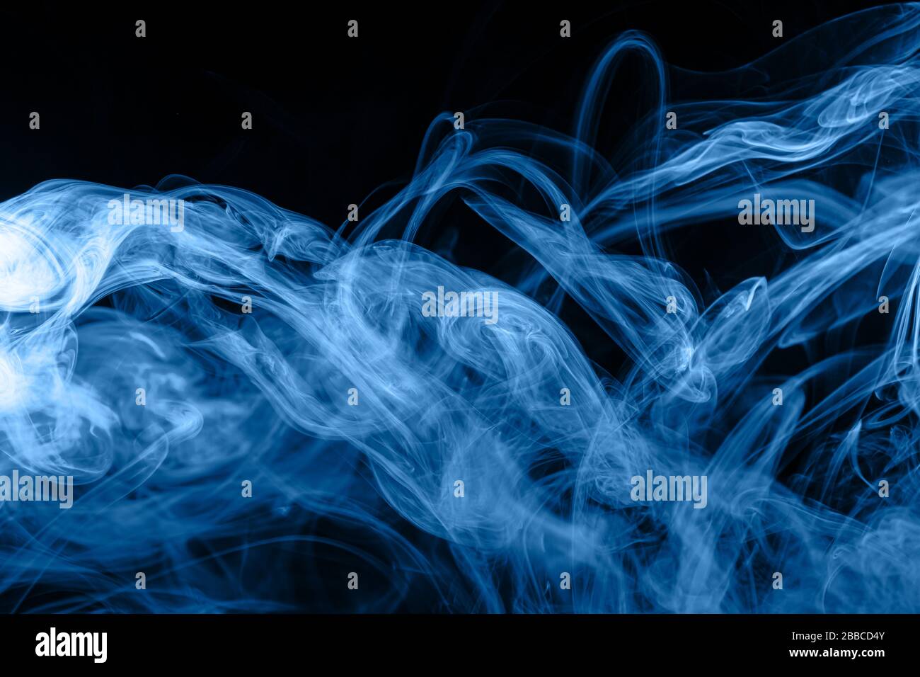 Colorful blue smoke on a black isolated background. Background from the ...