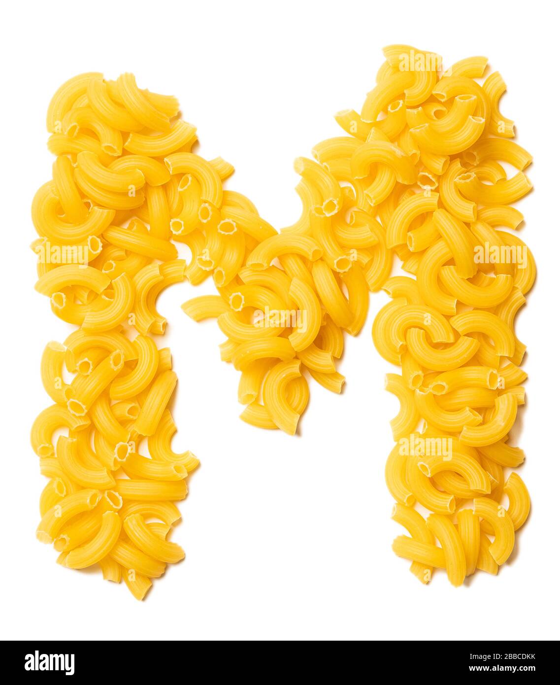 Letter M of the English alphabet from dry pasta on a white isolated ...