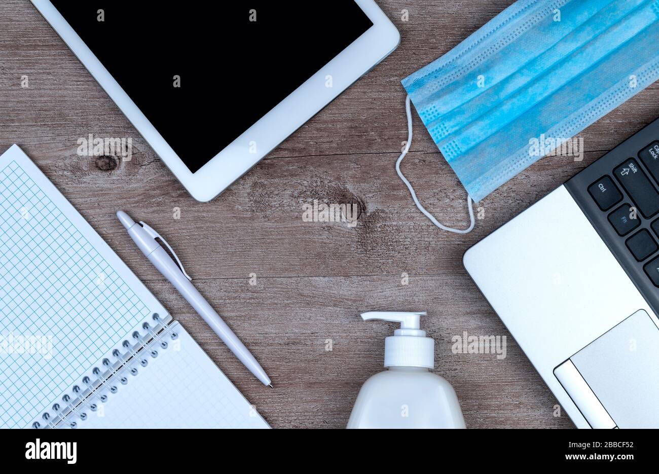 hygiene in the office. remote work kit on wooden desk. sanitizer gel ...
