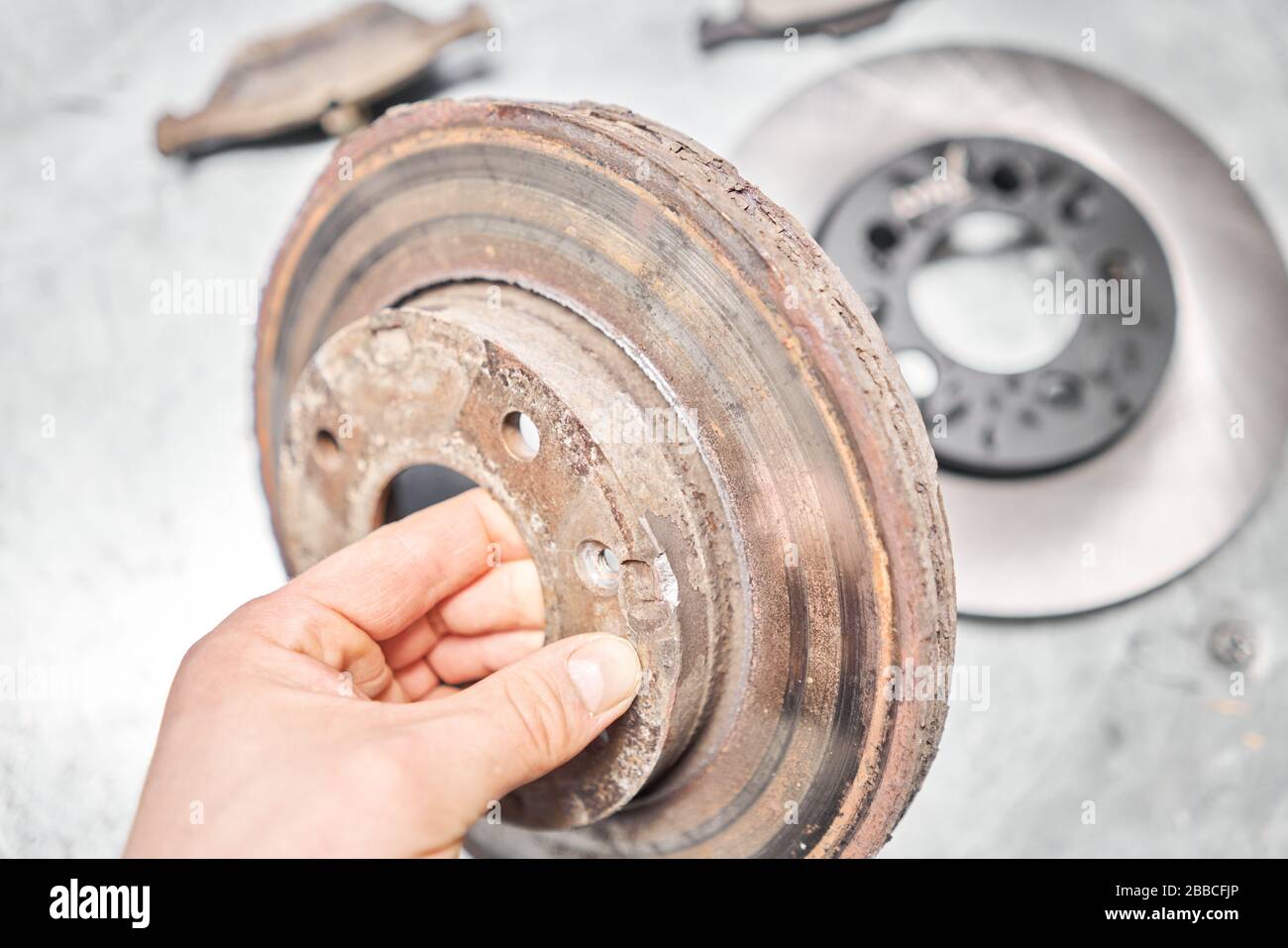 Old used and new to change for safety car brake disc and pad on metal ...