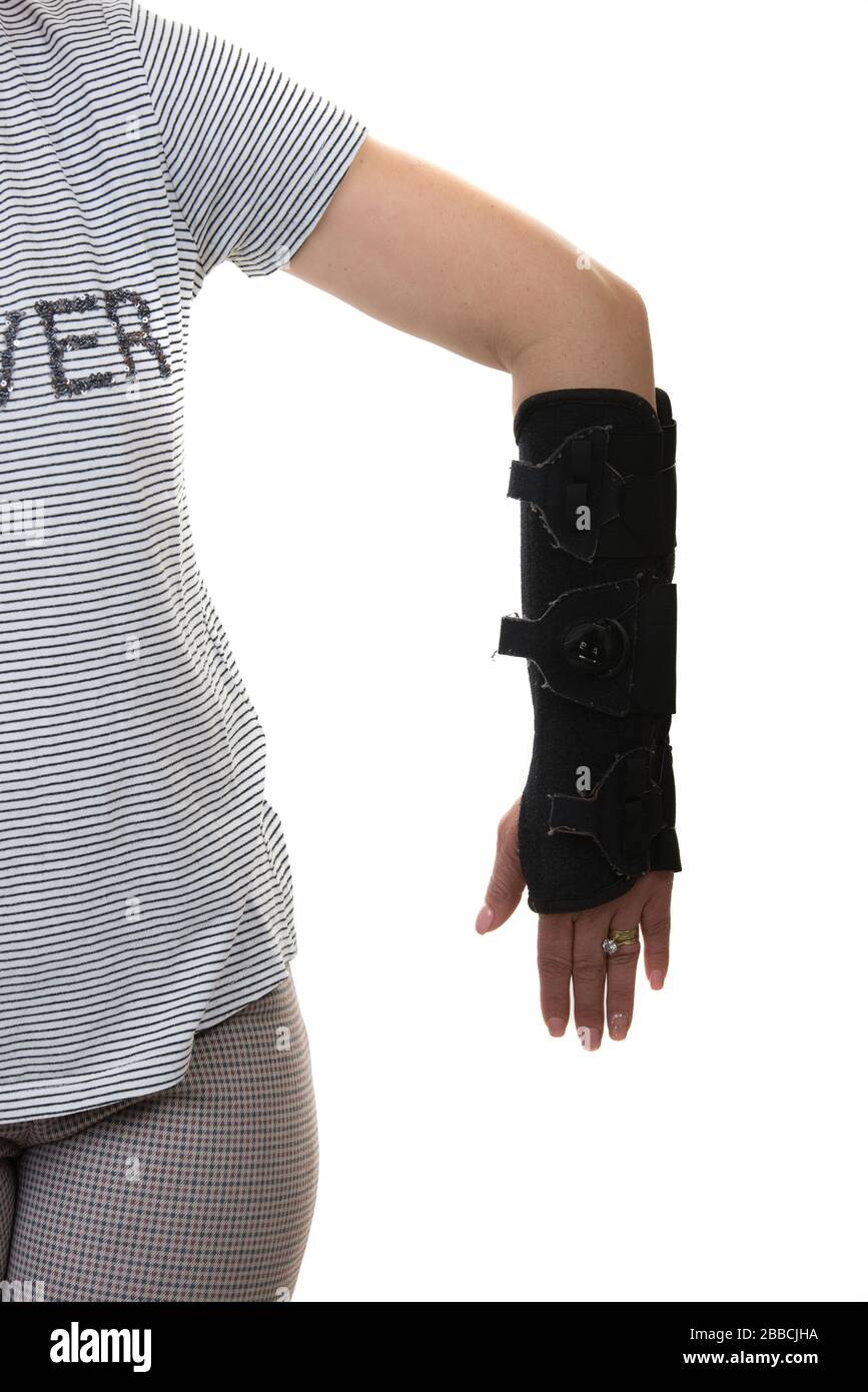 Close up of woman with left hand orthosis isolated on white background ...