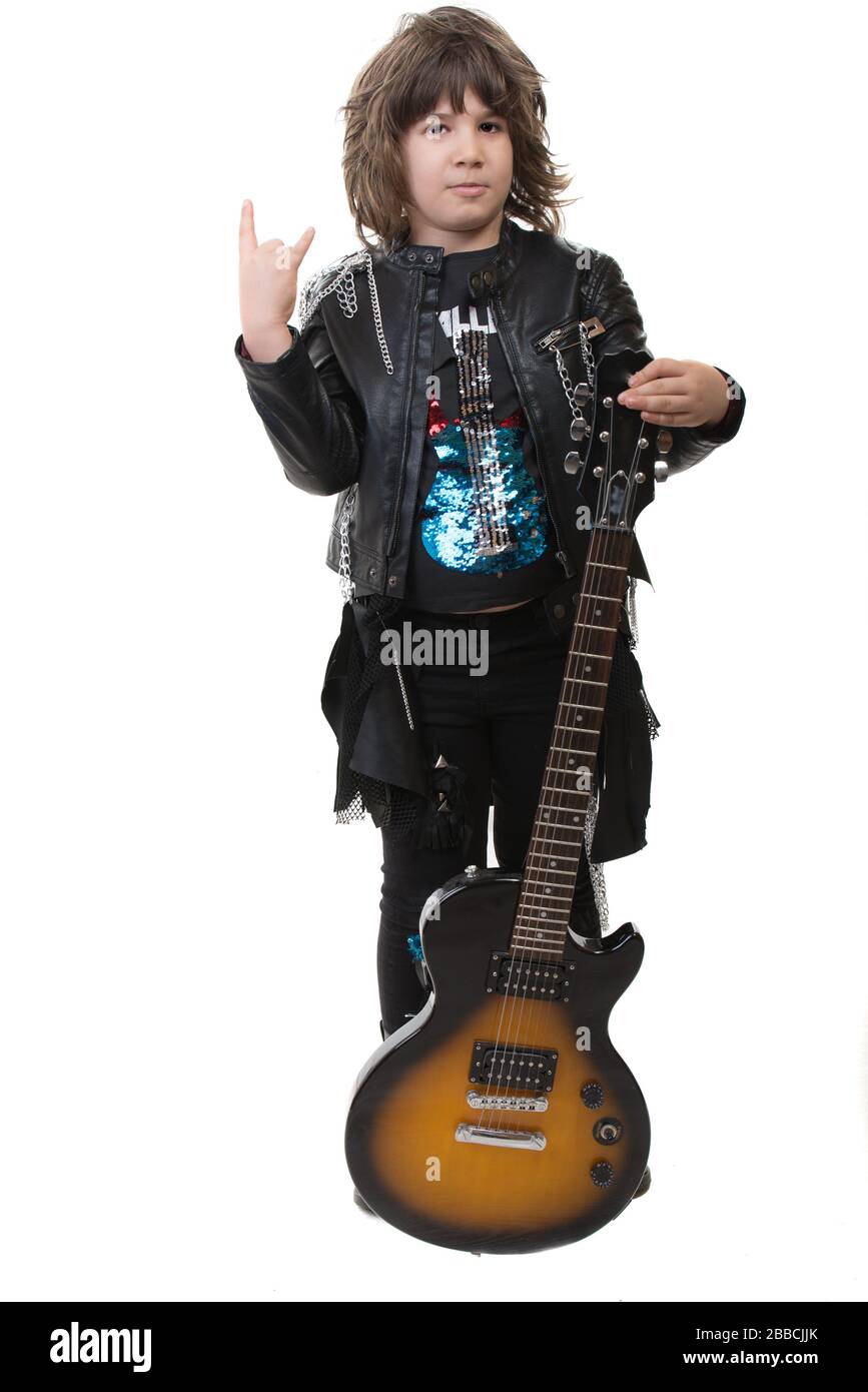 Full length of serious rocker boy with electric quitar showing rock and ...