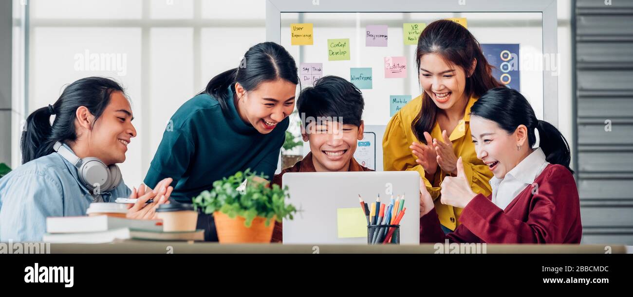 Asian ux developer and ui designer looking at laptop screen for ...
