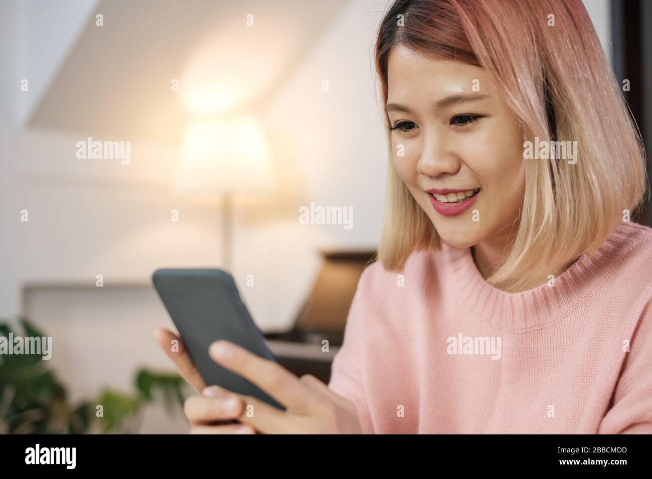 asian woman using mobile surfing internet and social media at home in ...