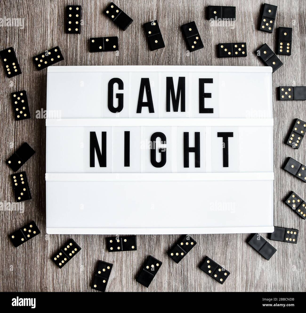 Game night text frame of dominoes with copy space inside on wooden ...