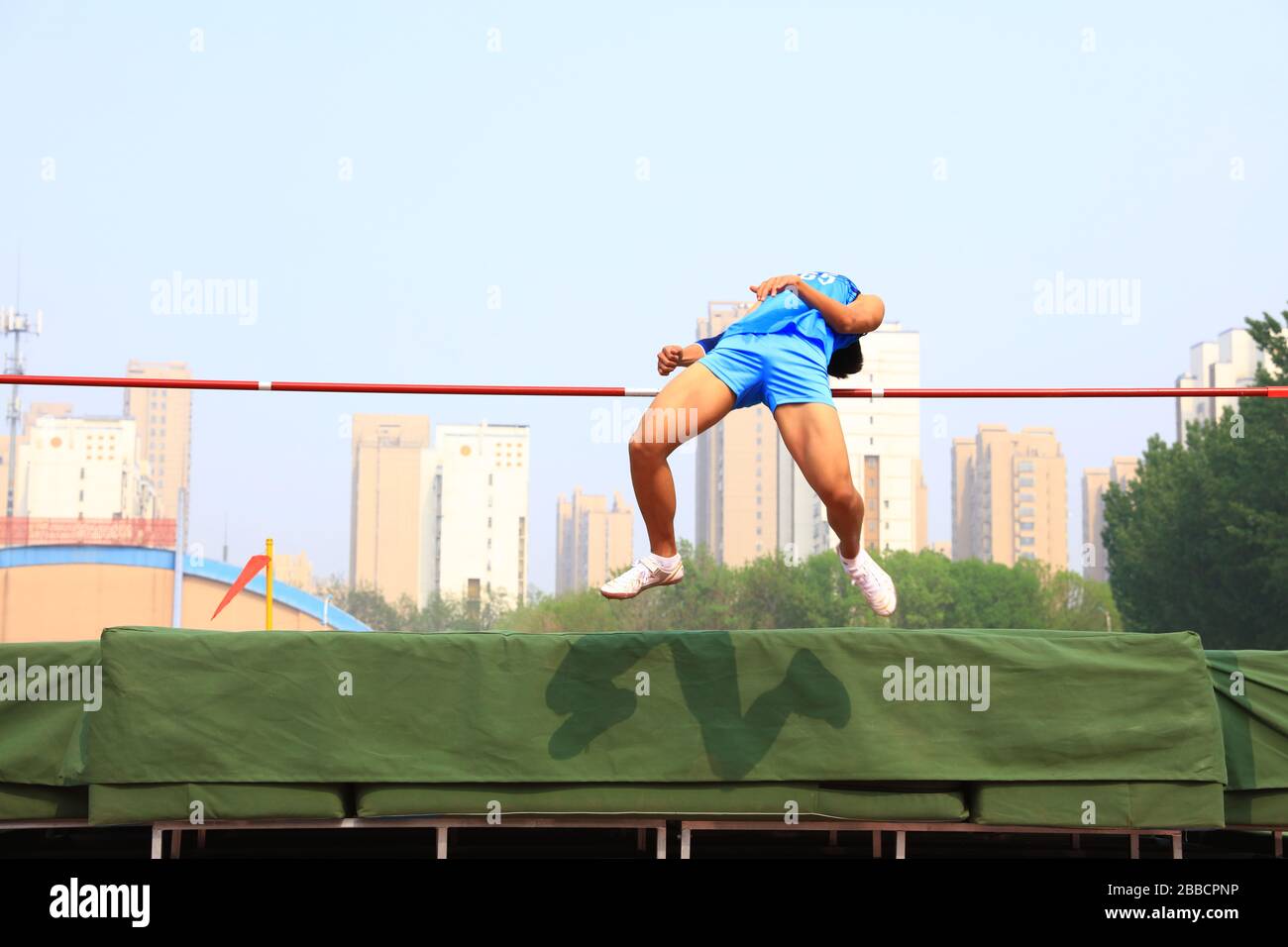 A male athlete is on the high jump Stock Photo - Alamy